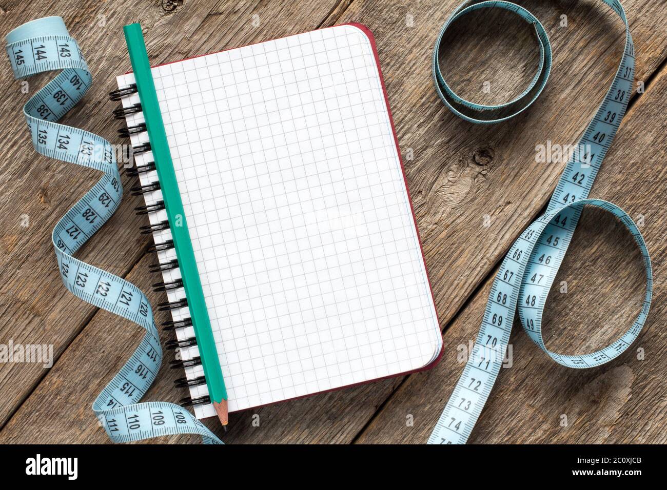 Measuring tape,pencil and blank notebook Stock Photo - Alamy