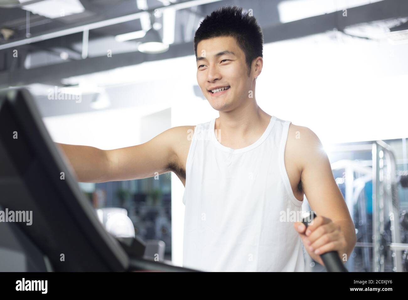 young man working out in modern gym Stock Photo - Alamy