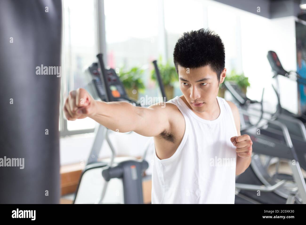 young man working out in modern gym Stock Photo - Alamy