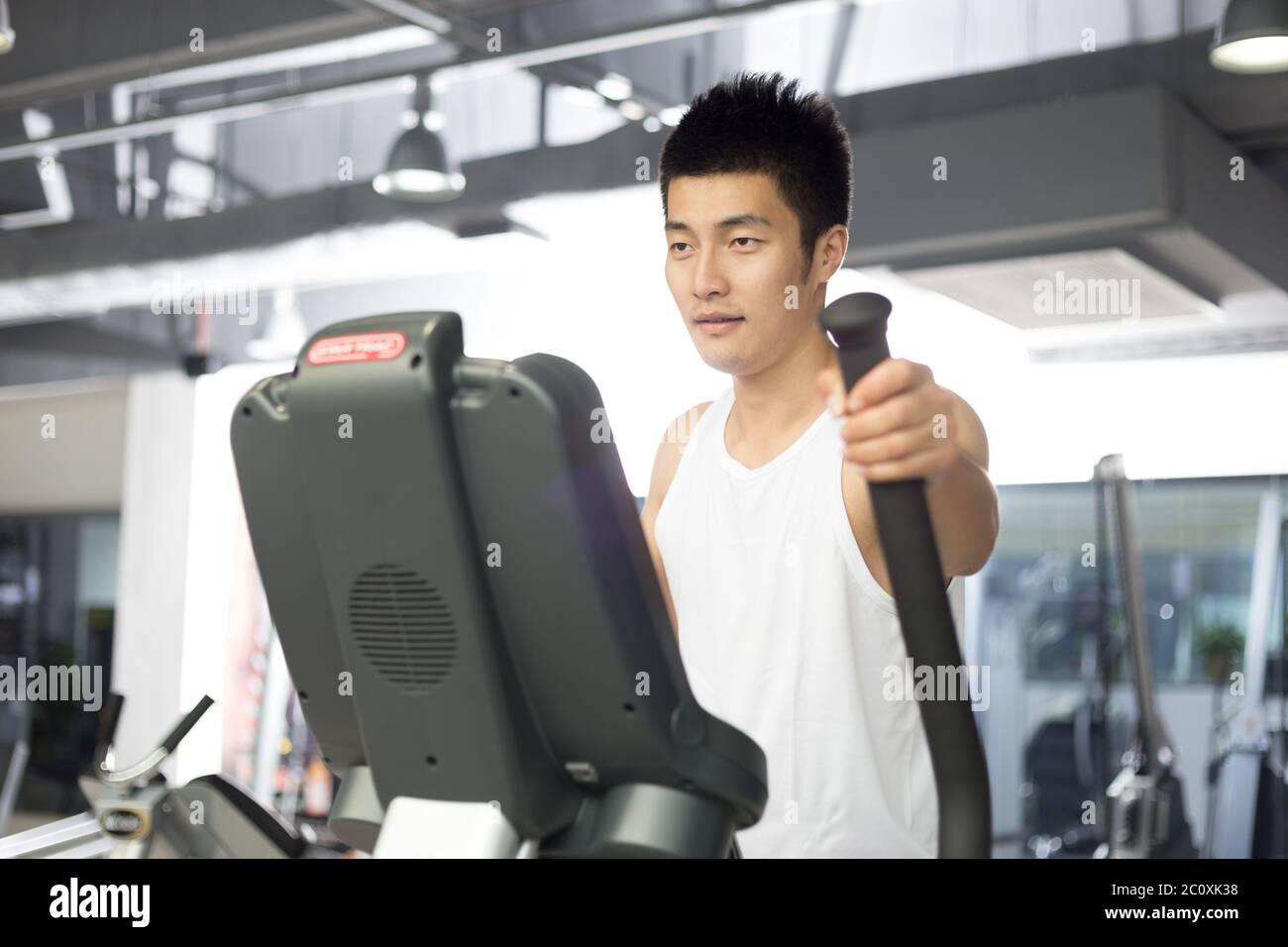 young man working out in modern gym Stock Photo - Alamy