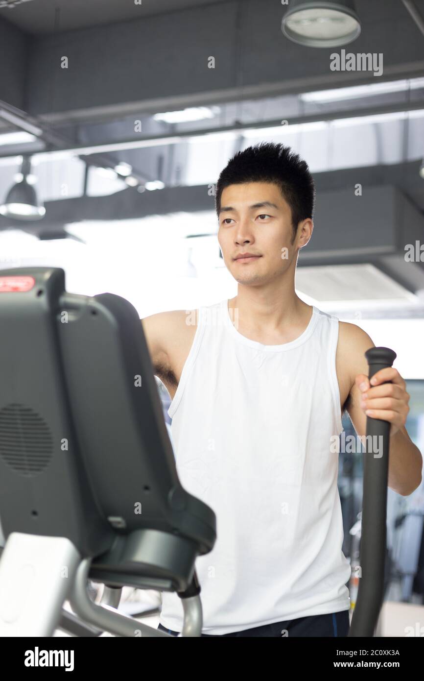 young man working out in modern gym Stock Photo - Alamy