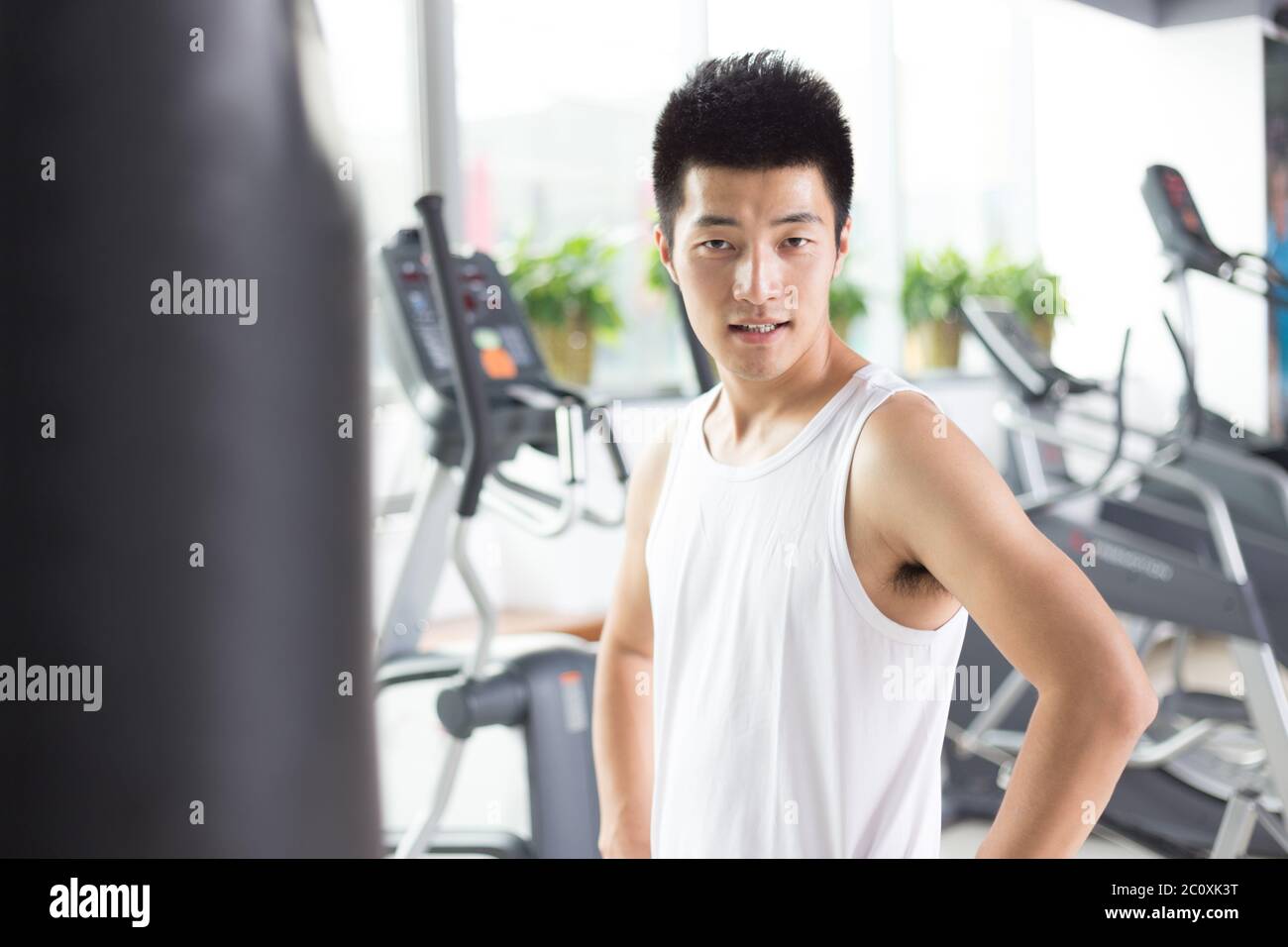 young man working out in modern gym Stock Photo - Alamy