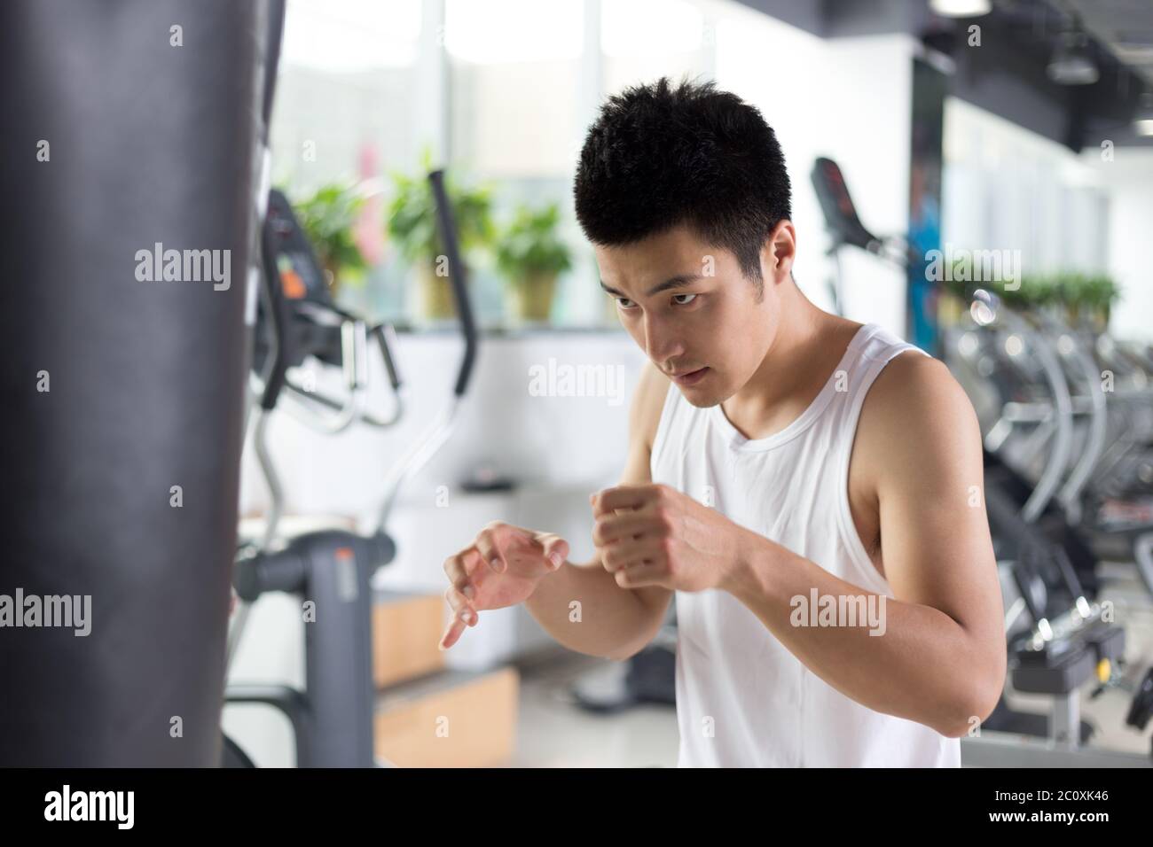 young man working out in modern gym Stock Photo - Alamy
