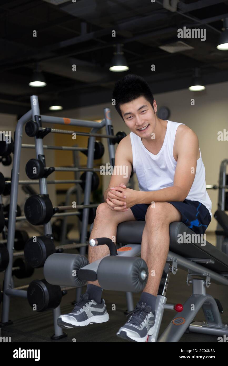 young man working out in modern gym Stock Photo - Alamy