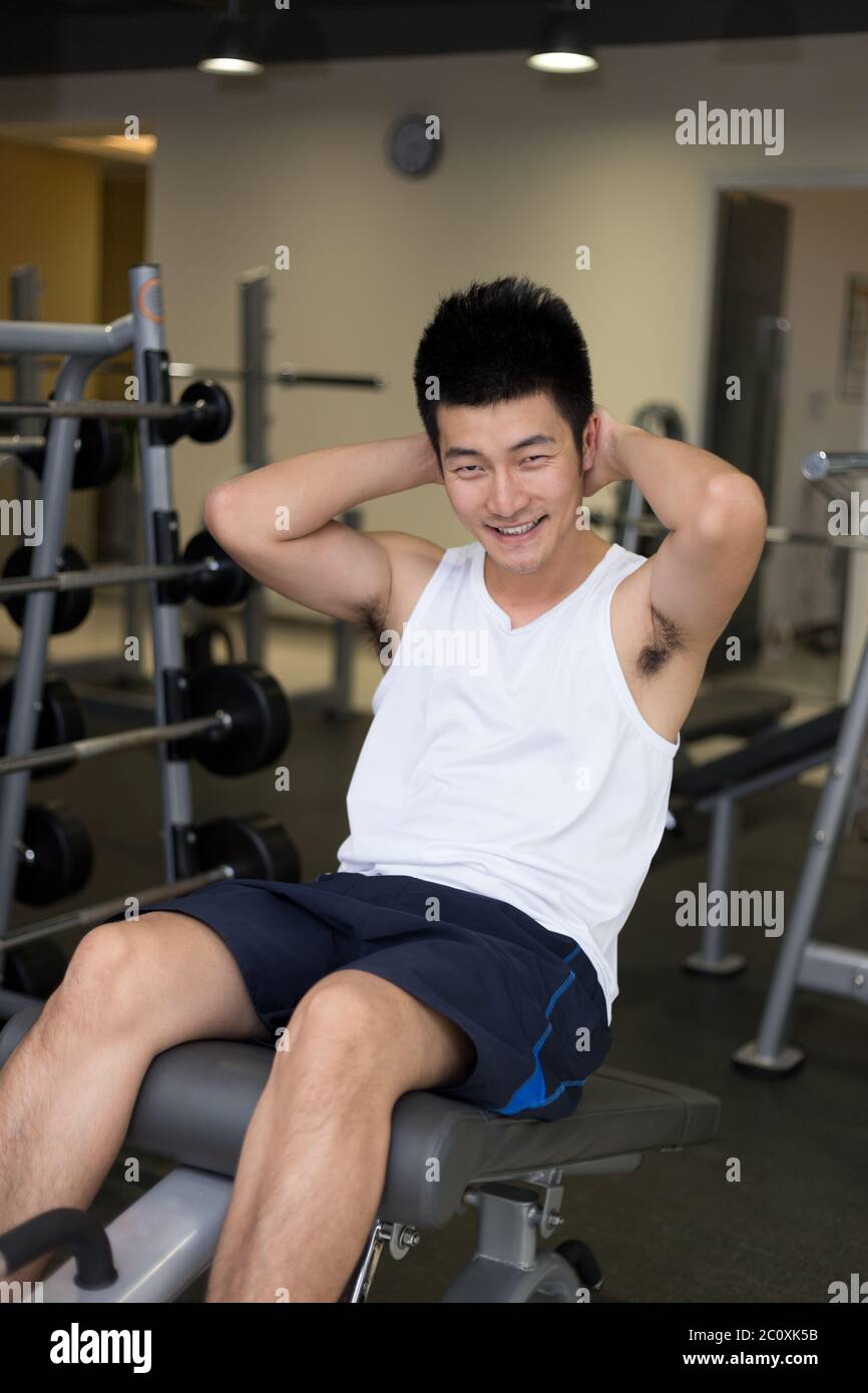 young man working out in modern gym Stock Photo - Alamy