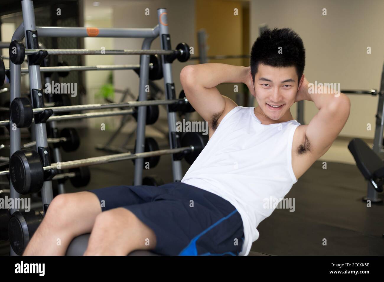 young man working out in modern gym Stock Photo - Alamy