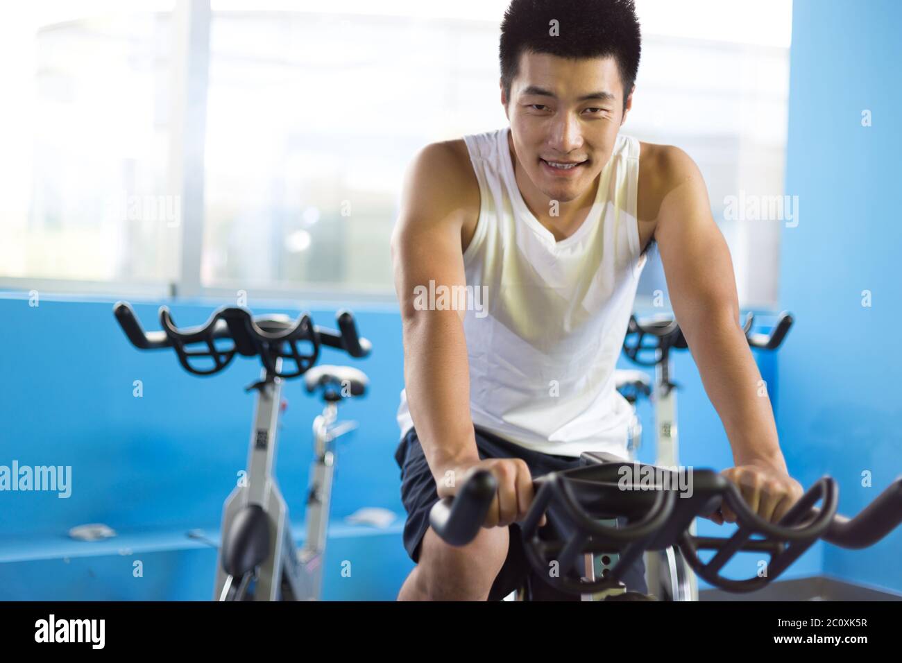 young man working out in modern gym Stock Photo - Alamy