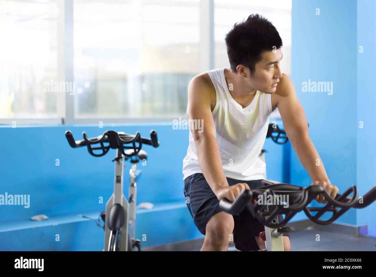 young man working out in modern gym Stock Photo - Alamy