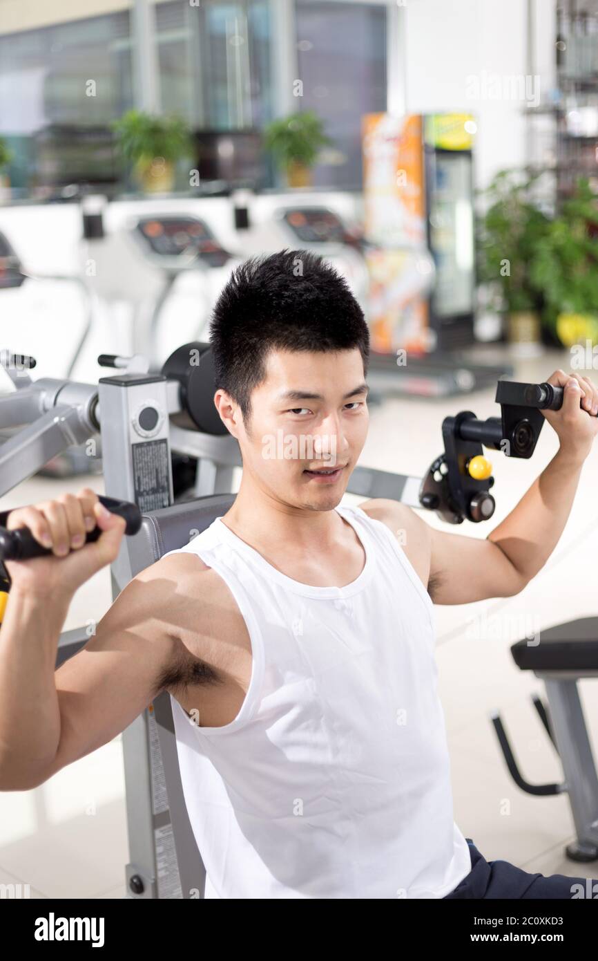 young man working out in modern gym Stock Photo - Alamy