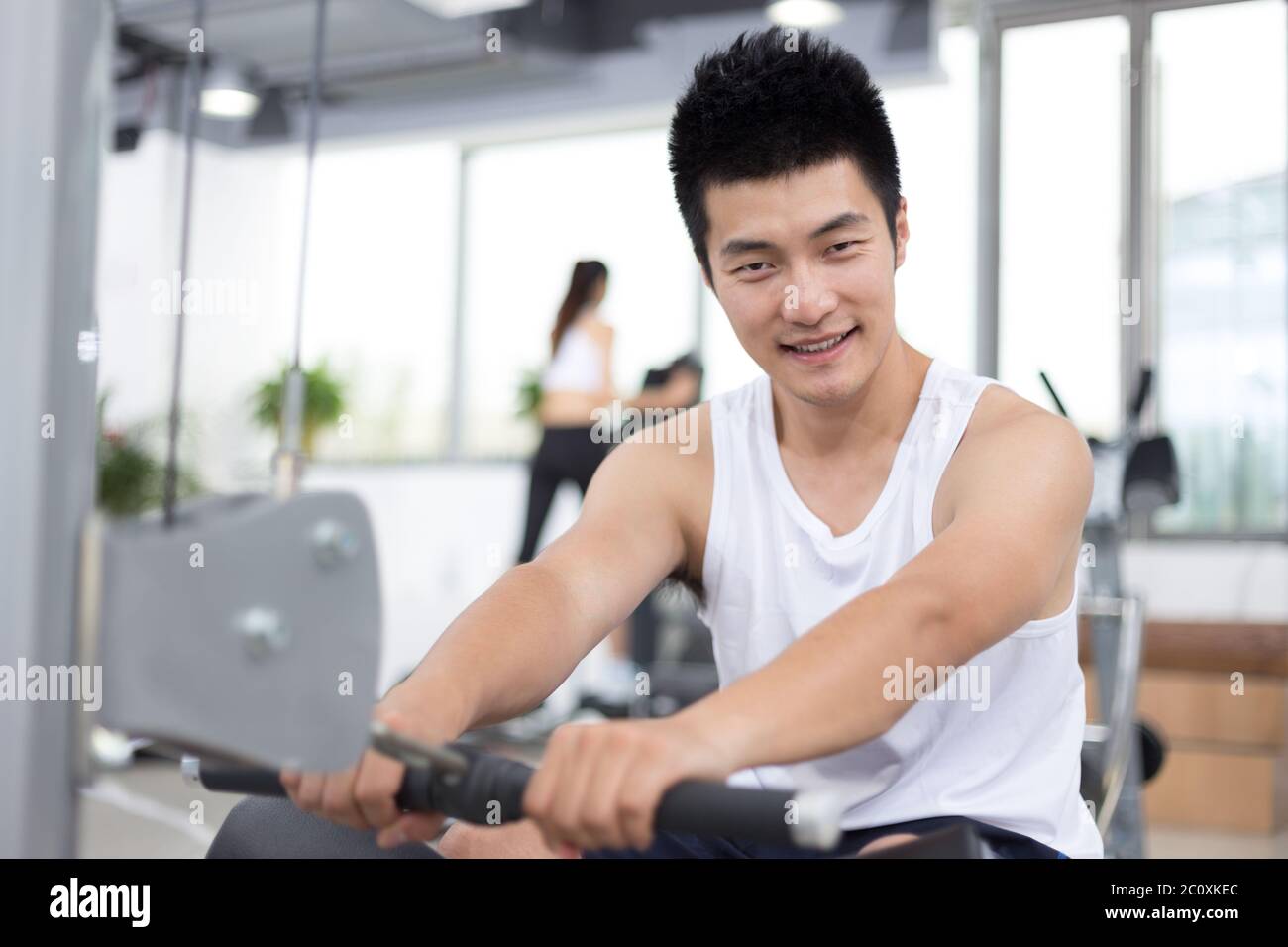 young man working out in modern gym Stock Photo - Alamy