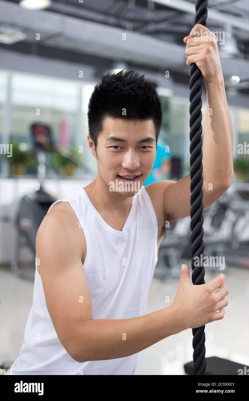young man working out in modern gym Stock Photo - Alamy