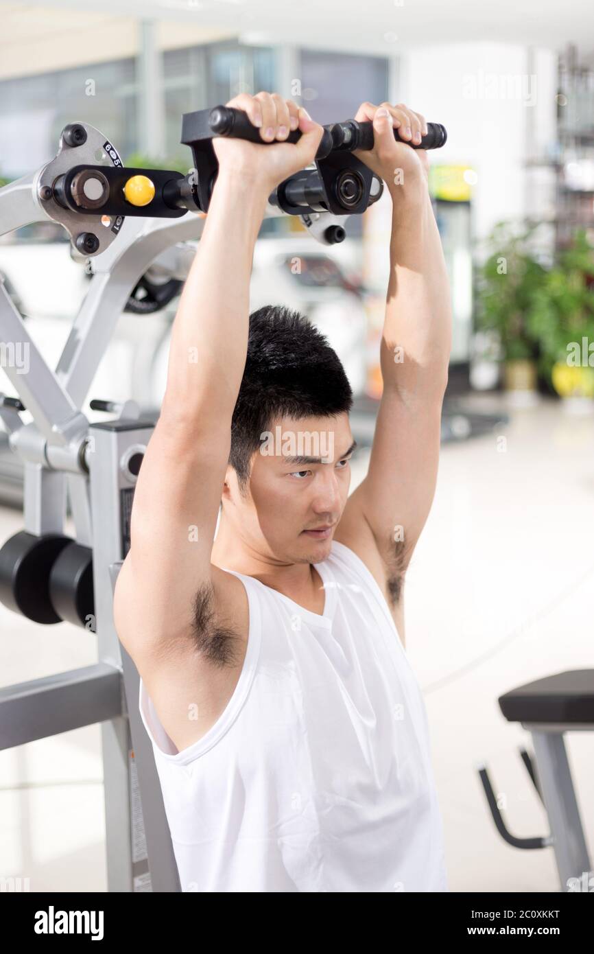young man working out in modern gym Stock Photo - Alamy