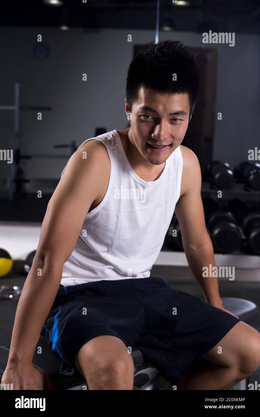 young man working out in modern gym Stock Photo - Alamy