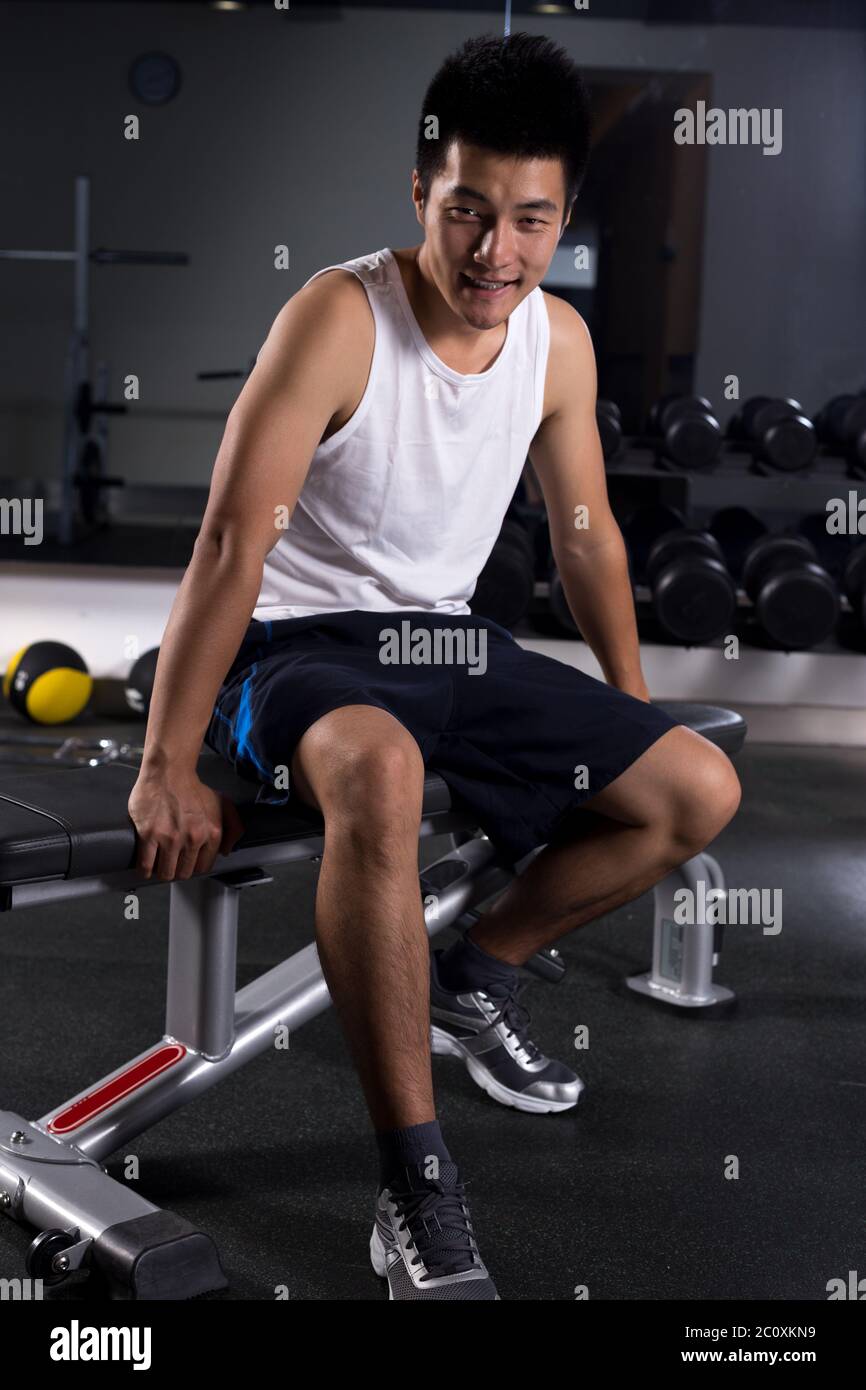 young man working out in modern gym Stock Photo - Alamy