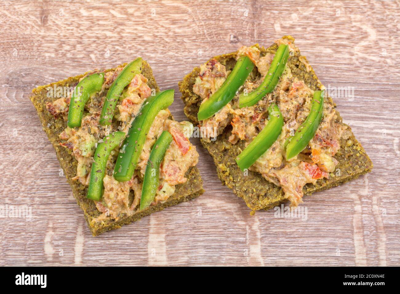 Raw bread with a spread decorated with pepper Stock Photo - Alamy