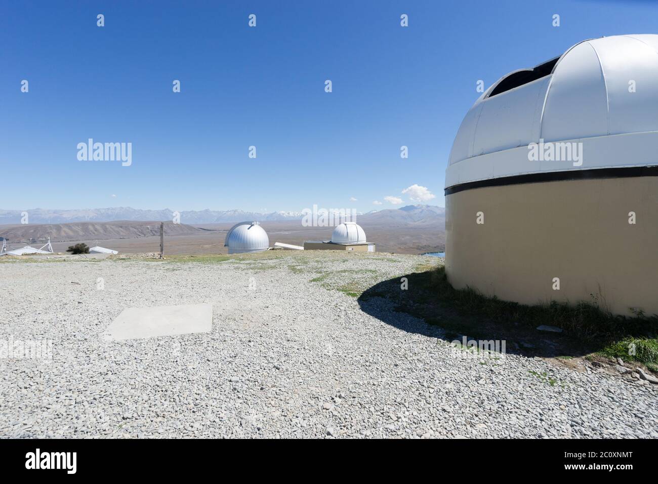 round building on ground near lake in summer day in new zealand Stock ...