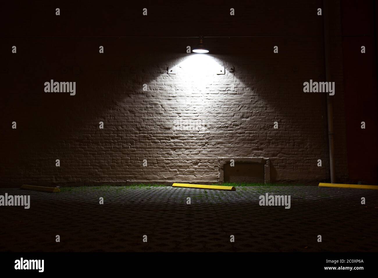 brick floor and wall with a light in seattle at night Stock Photo - Alamy