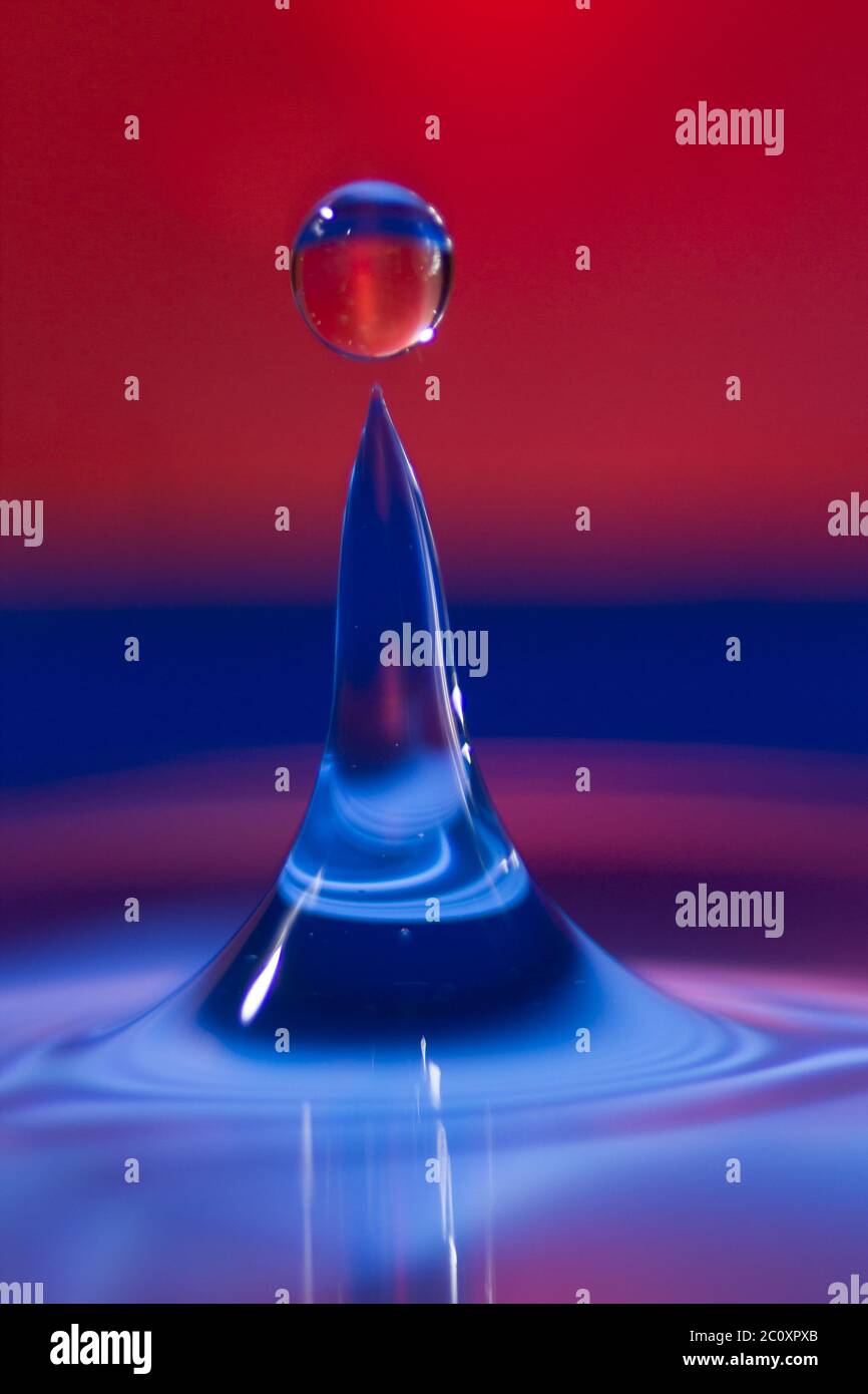 blue water drop close up with red and blue colorful background Stock ...