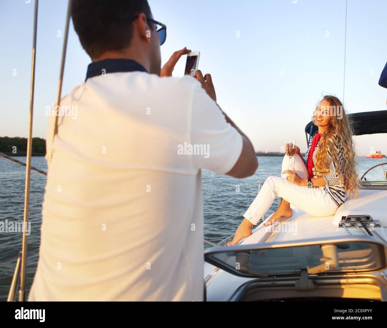 Beautiful couple taking a photo on a sailing boat at summer Stock Photo ...