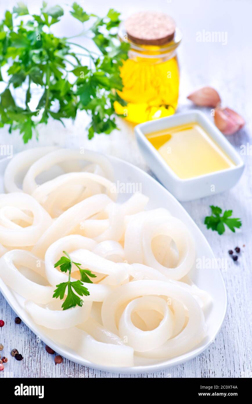 Raw squid rings with pepper Stock Photo - Alamy