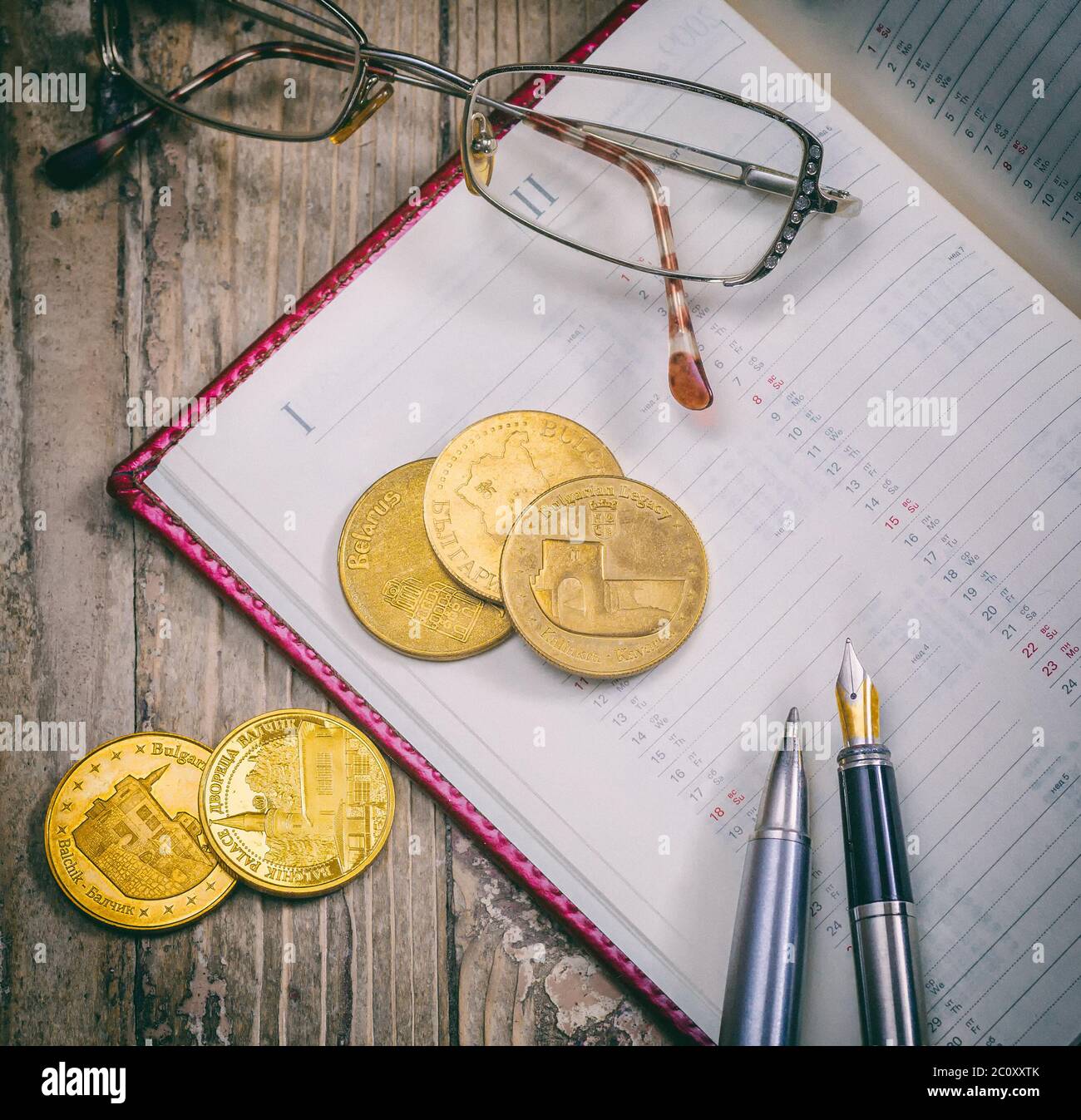 Coins and pen, business Stock Photo - Alamy