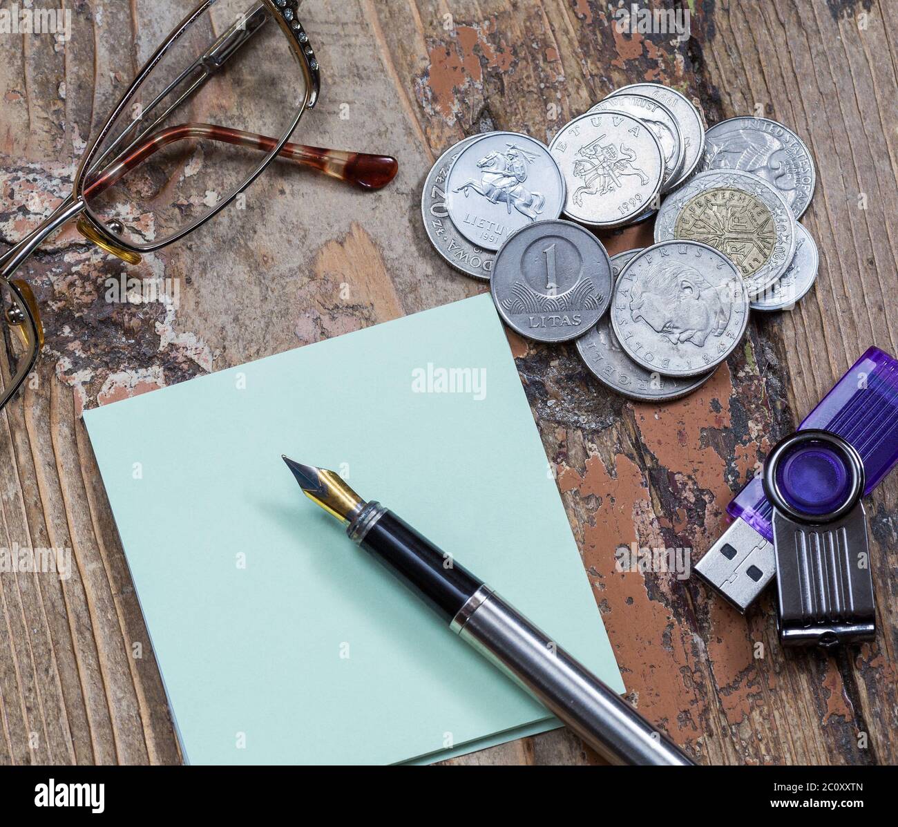 Coins and pen Stock Photo - Alamy