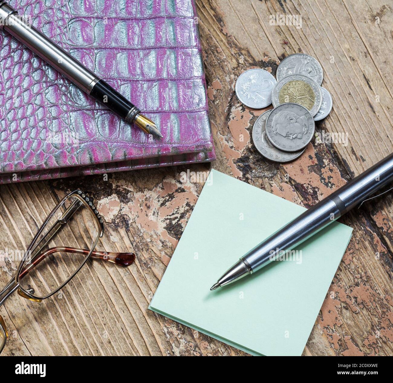 Coins and pen Stock Photo - Alamy
