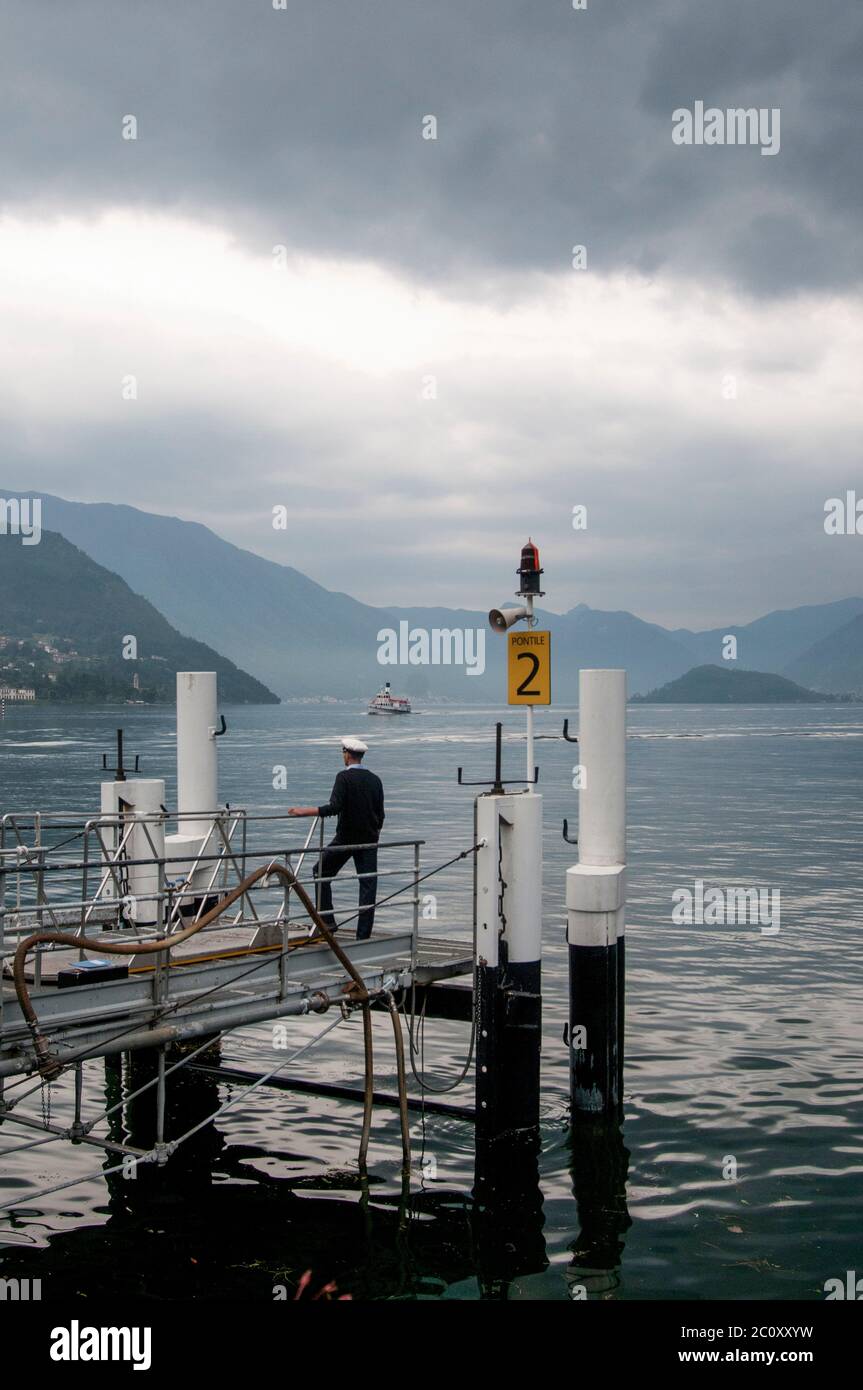 Storm clouds overhang the ferry jetty at Bellagio on Lake Como ...