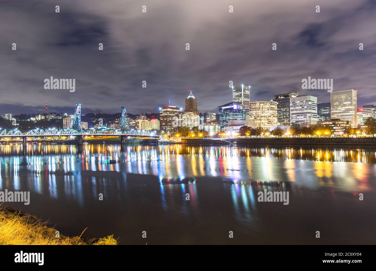 water with reflection and cityscape and skyline of portland at night ...