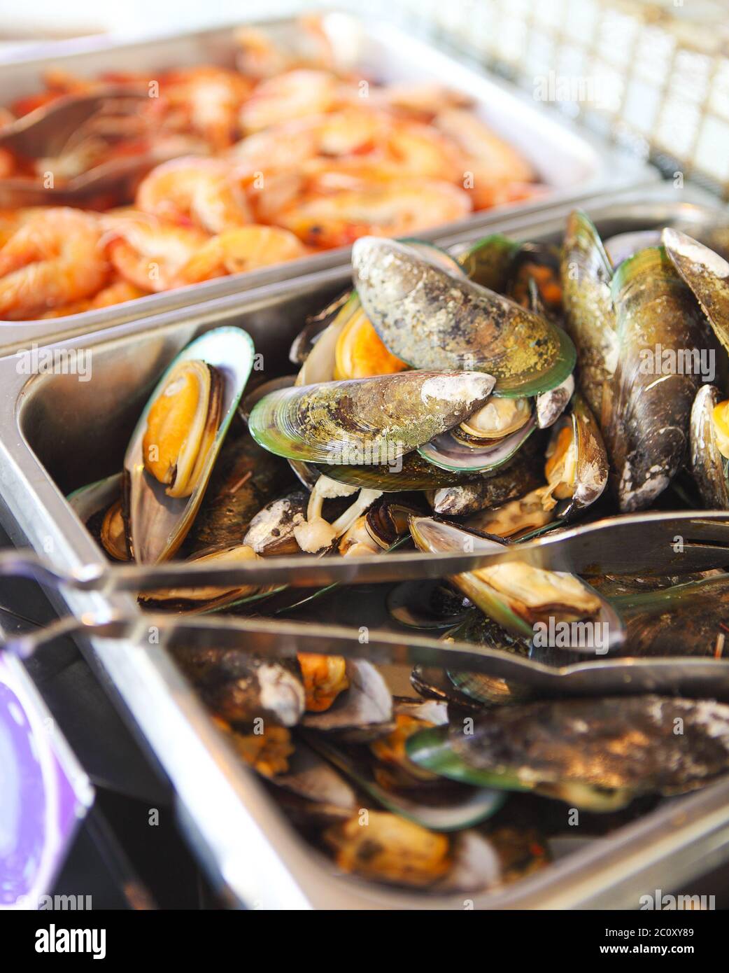 Buffet table with seafood with shrimps, fried calamari rings and ...