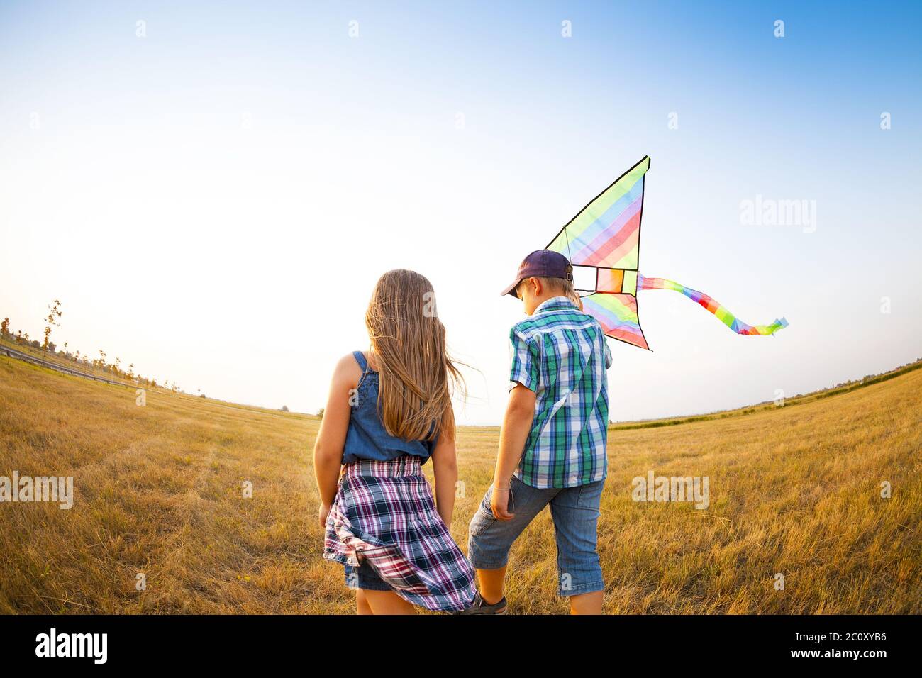 Little children playing with flying kite on the summer field Stock ...