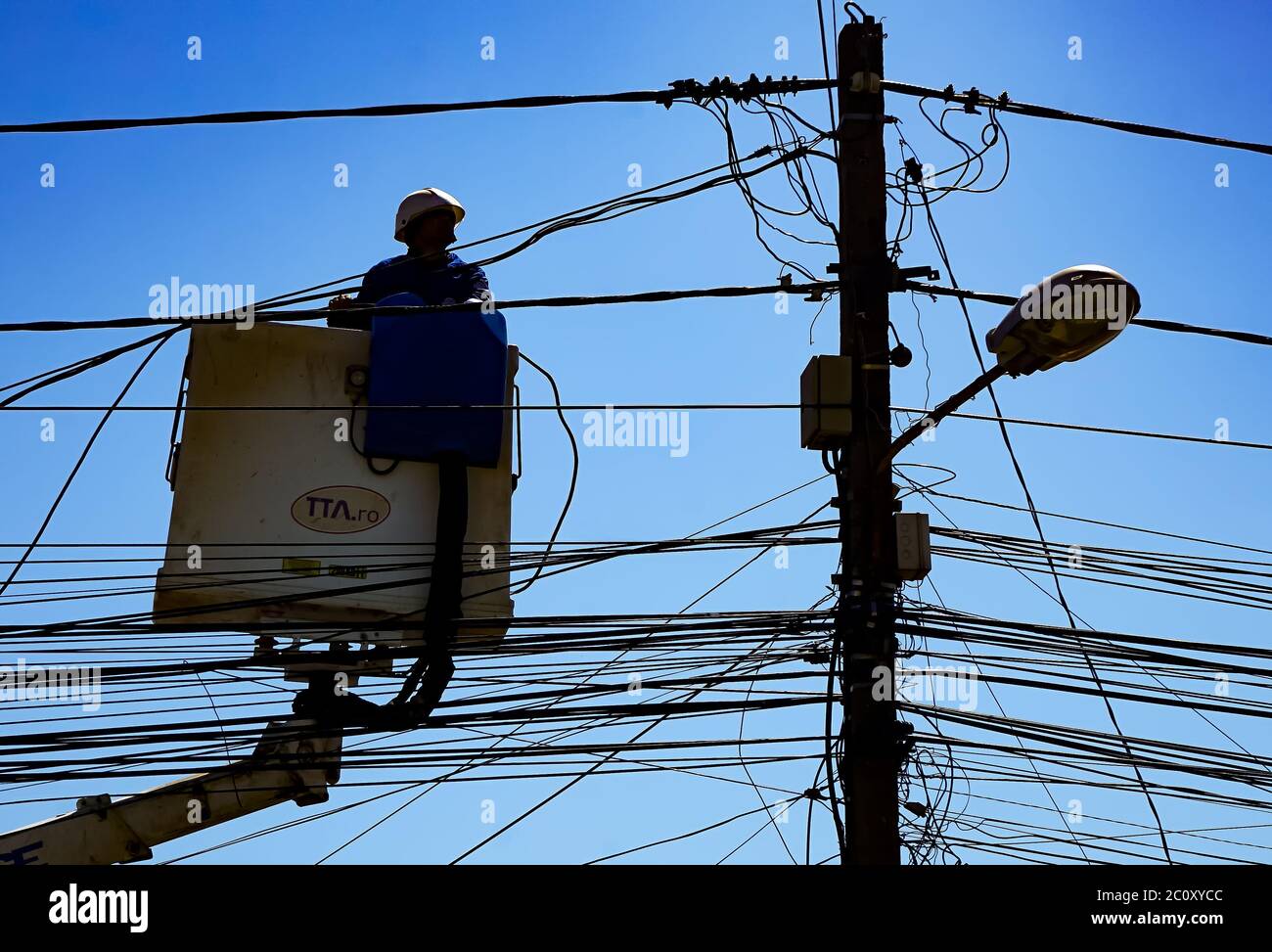 Bucharest, Romania - April 06, 2019: An electrician repairs a high ...