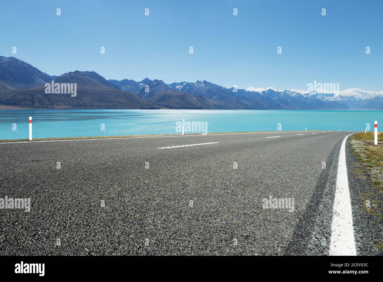 Road near water mountains hi-res stock photography and images - Alamy