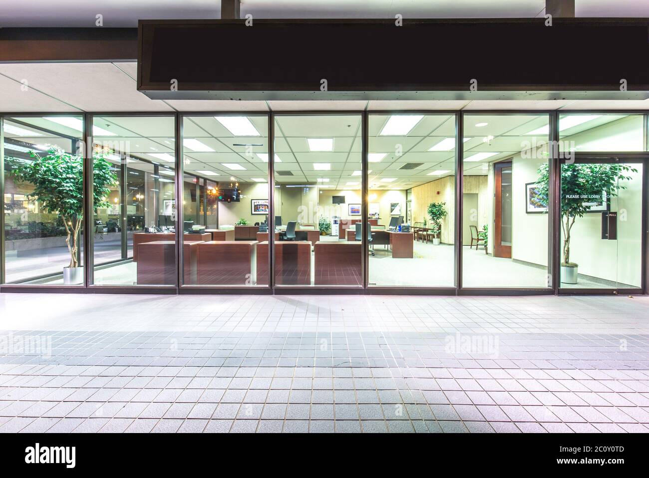 modern office building and empty brick footpath at night Stock Photo ...