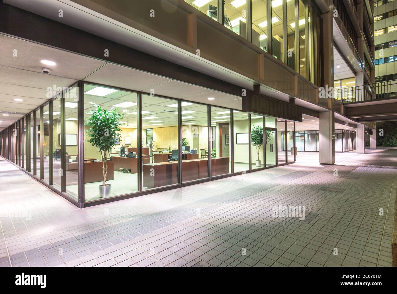 modern office building and empty brick footpath at night Stock Photo ...