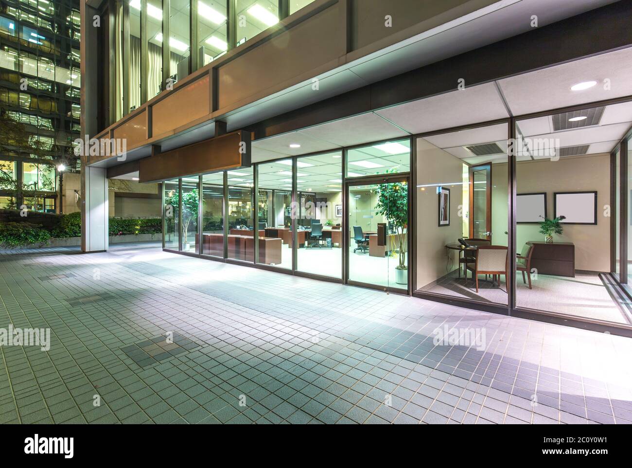 modern office building and empty brick footpath at night Stock Photo ...