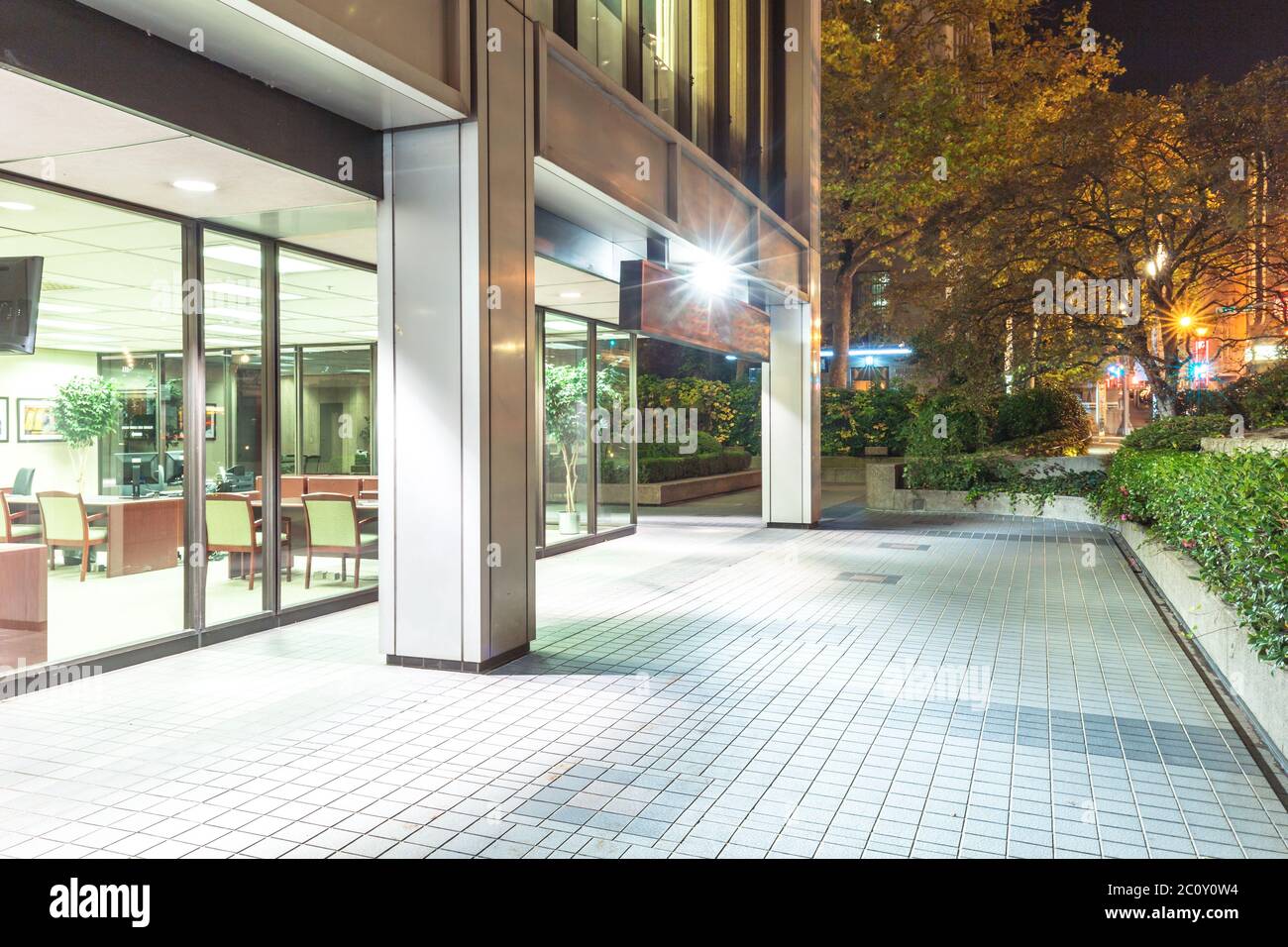 modern office building and empty brick footpath at night Stock Photo ...