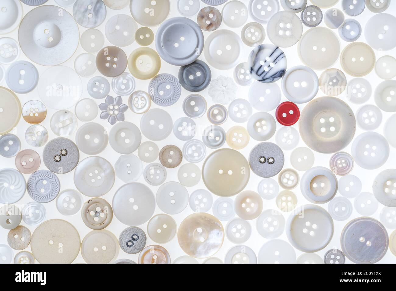 Lots of different colored and shaped buttons on a white background ...