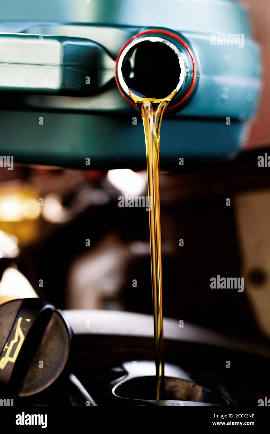 Fresh oil being poured during an oil change to a car Stock Photo - Alamy