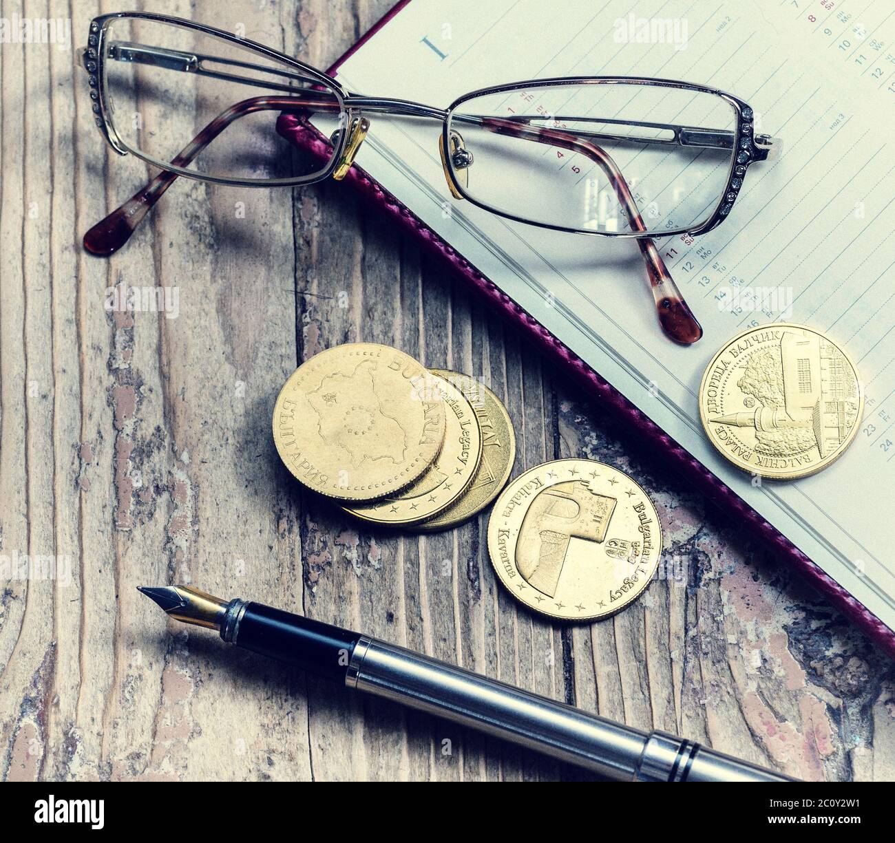 Coins and pen, business Stock Photo - Alamy