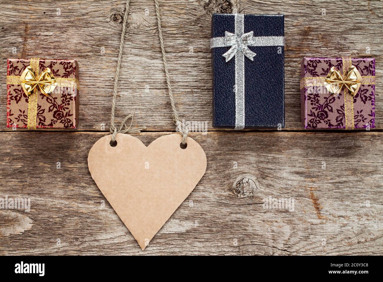 Heart shaped tag and three gift boxes Stock Photo - Alamy