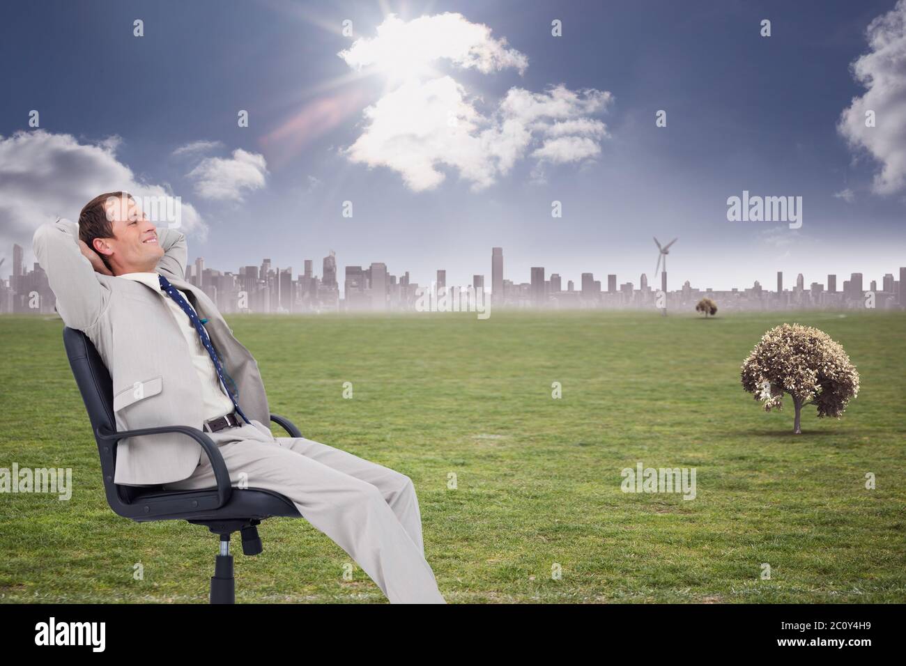 Composite image of side view of businessman leaning back in his chair ...