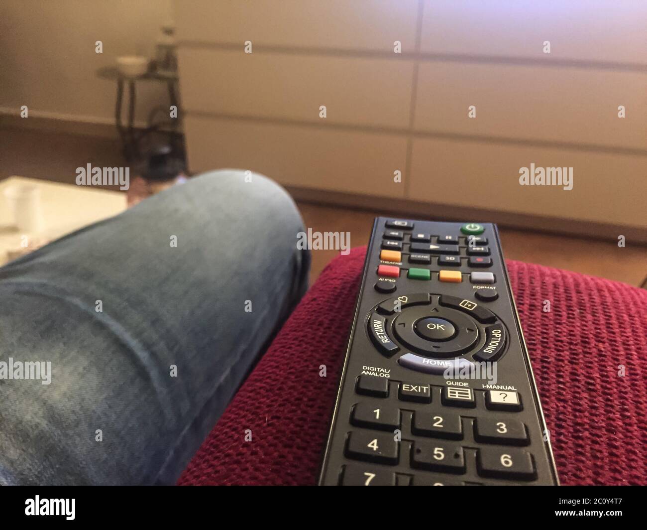 Remote control on a couch Stock Photo - Alamy