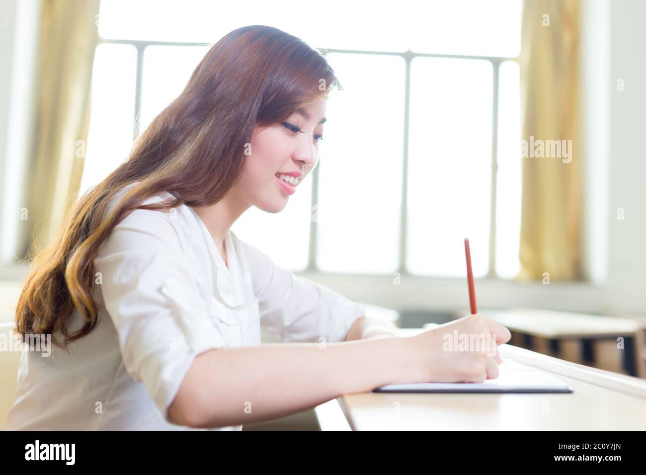 young beautiful asian girl student in classroom Stock Photo - Alamy
