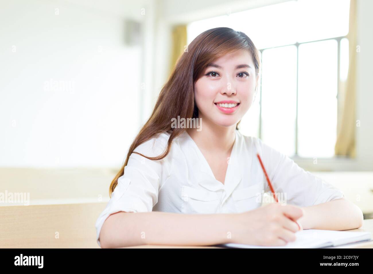 young beautiful asian girl student in classroom Stock Photo - Alamy