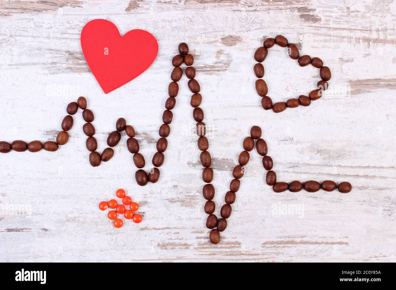 Electrocardiogram line of roasted coffee grains, red heart and ...