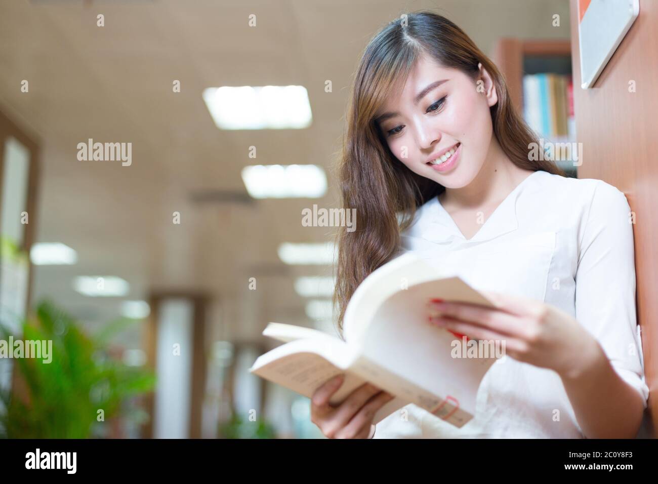 young beautiful asian girl student in library Stock Photo - Alamy