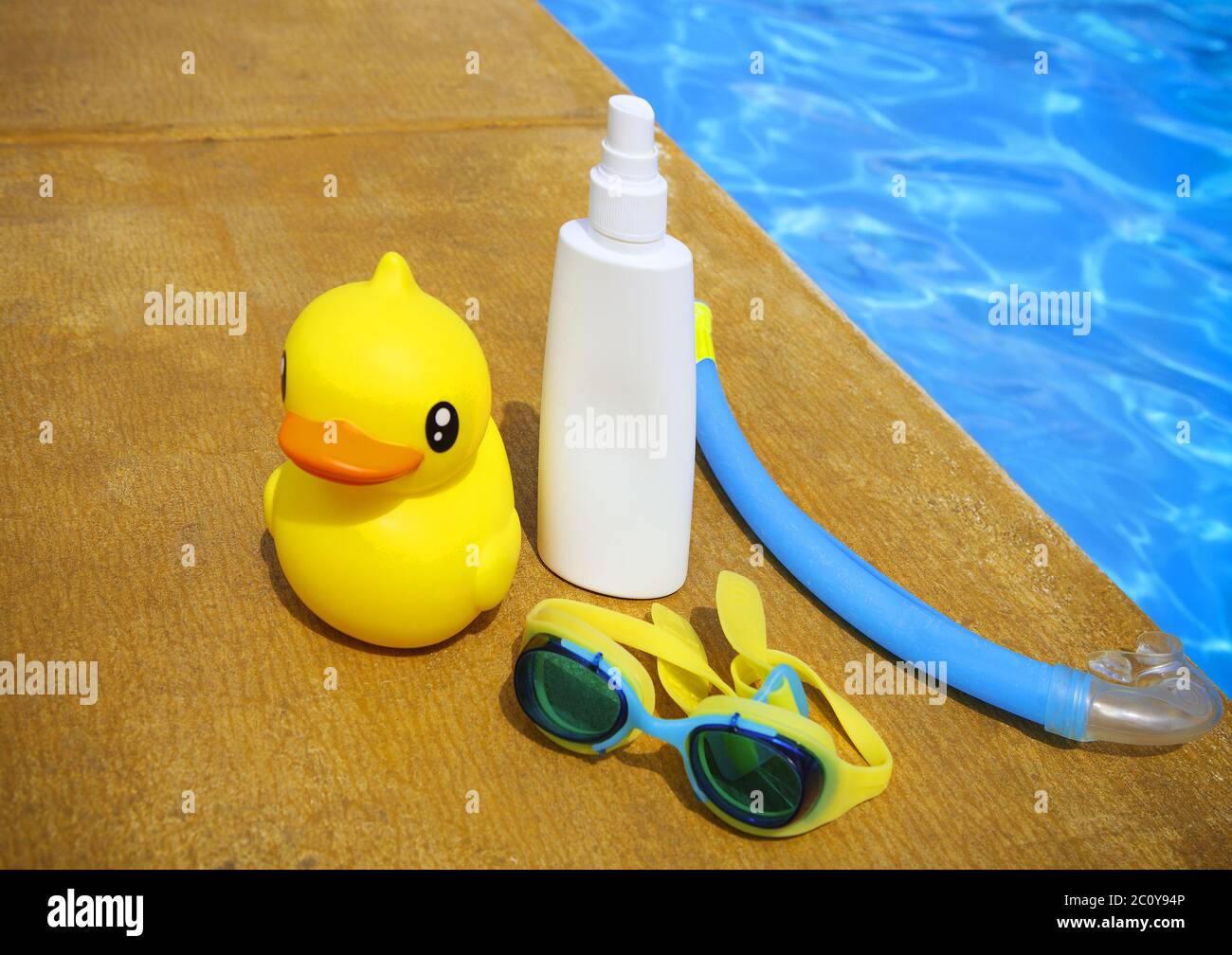 Suncream, snorkel, goggles and yellow rubber duck Stock Photo - Alamy