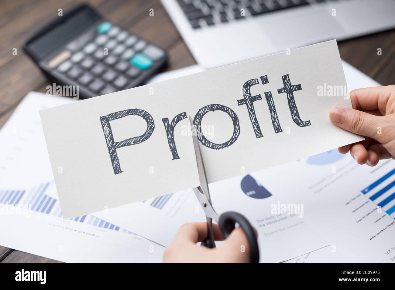holds card with text on financial report and calculator Stock Photo - Alamy