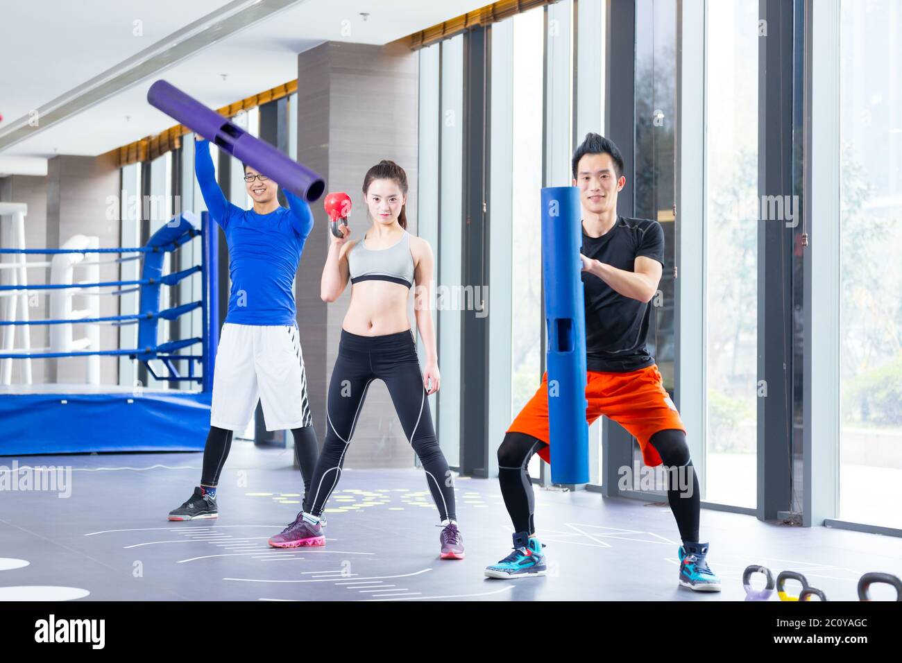 young asian people doing yoga in modern gym Stock Photo - Alamy